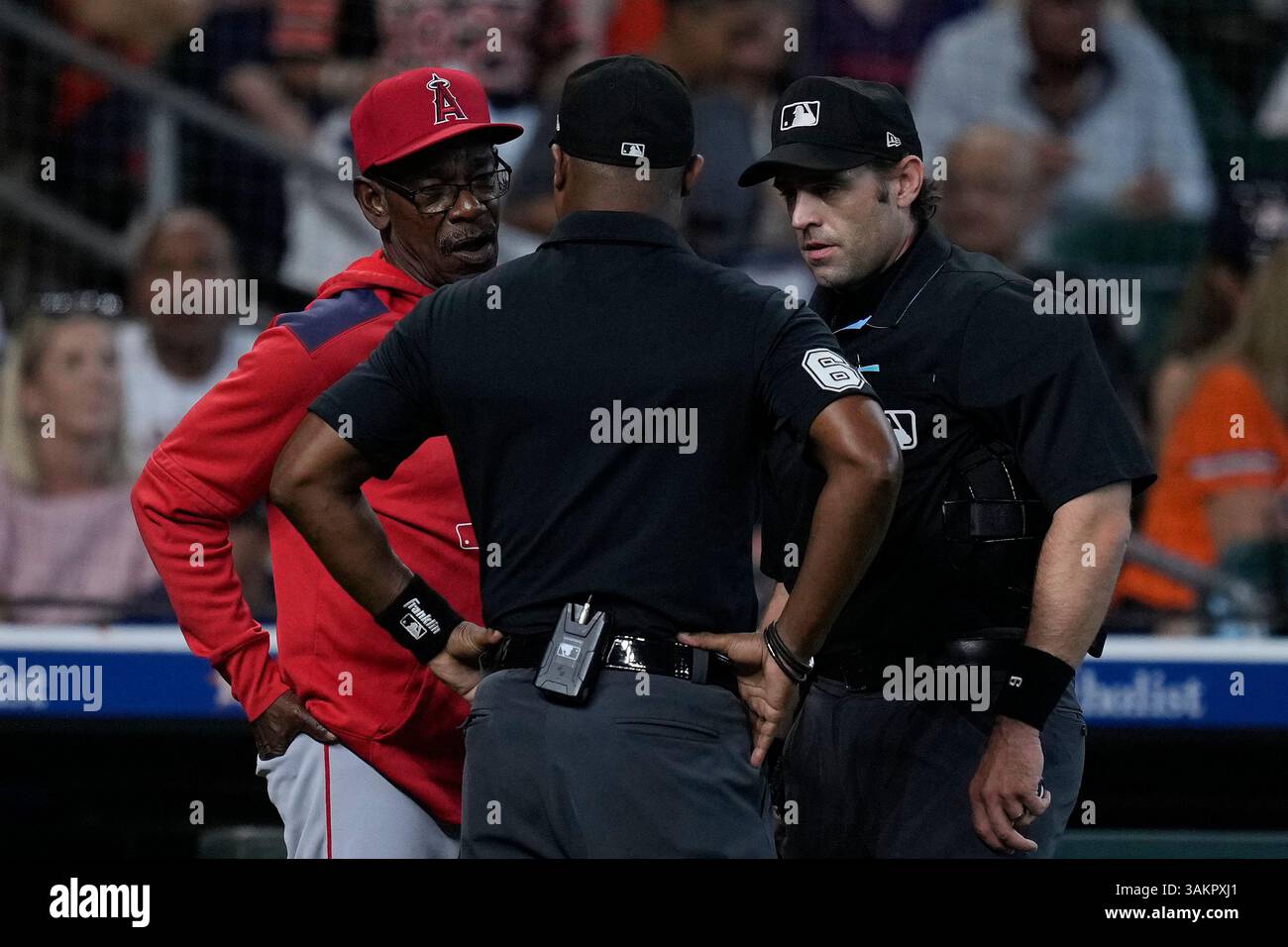 Los Angeles Angels manager Ron Washington (37) talks with umpires Alan ...