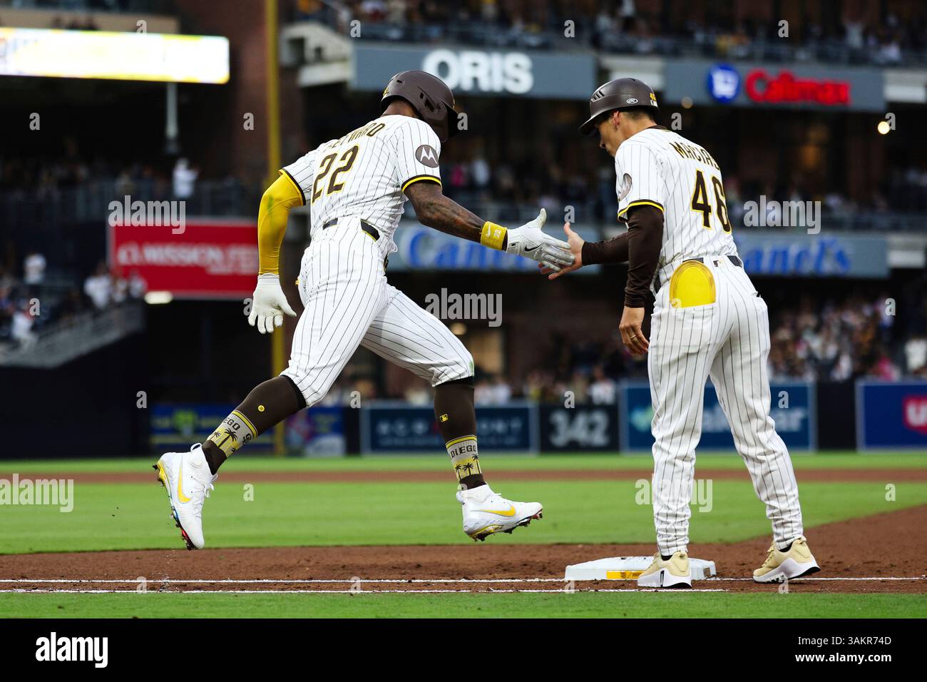 San Diego Padres' Jason Heyward, left, is congratulated by first base ...