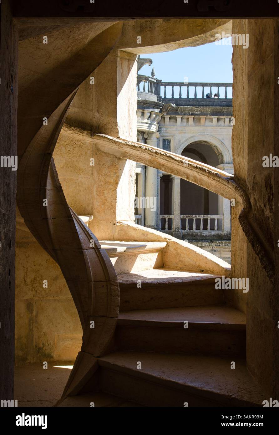 Stone carved spiral stairs from the middle ages next to a cloister, sun ...