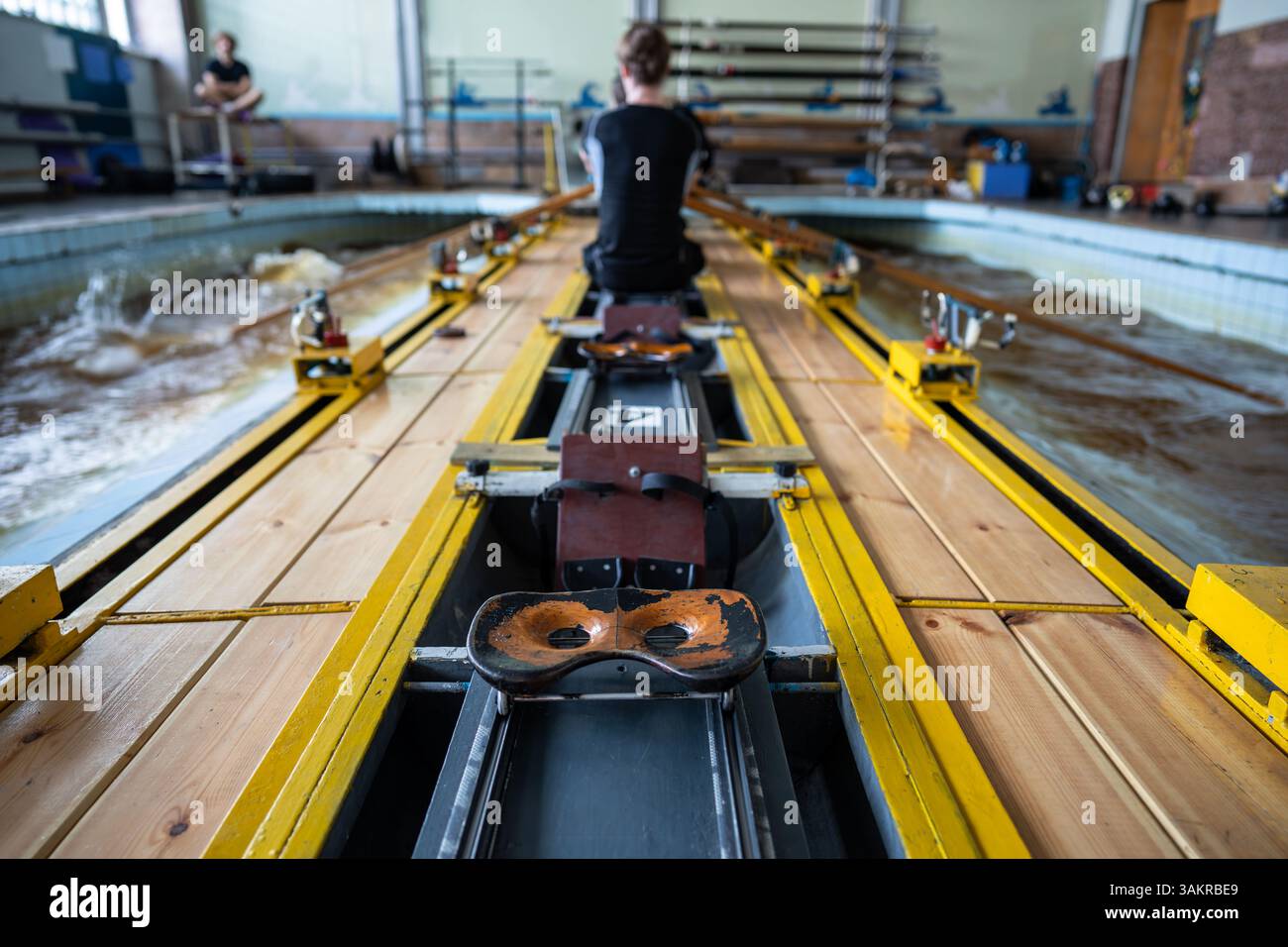 Elite paddlers practice synchronized strokes on row simulator boat for ...