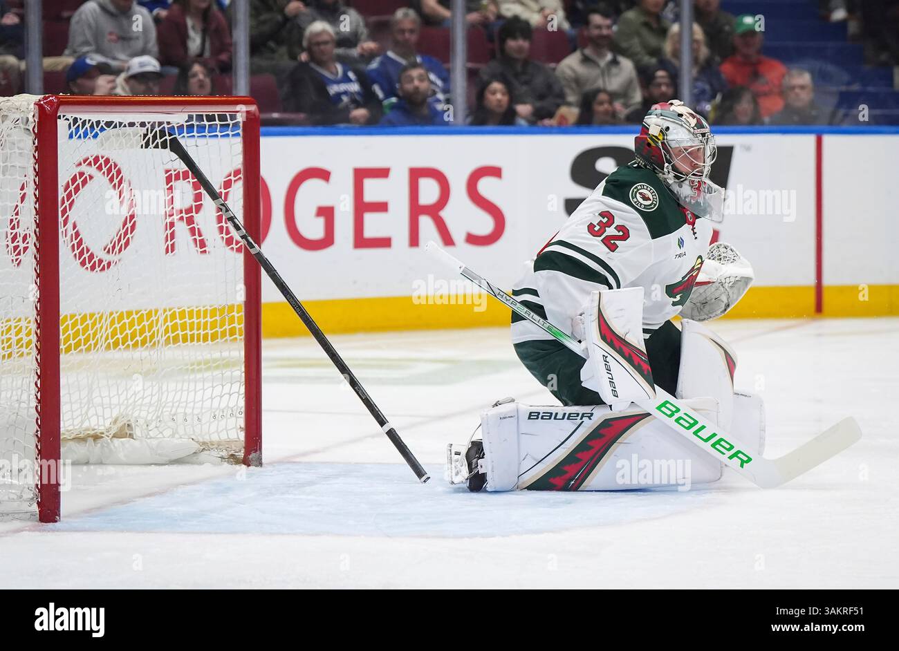 Minnesota Wild goalie Filip Gustavsson watches the play as a stick is ...