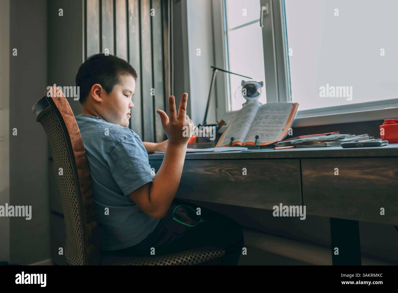 Asian boy counting on fingers hi-res stock photography and images - Alamy