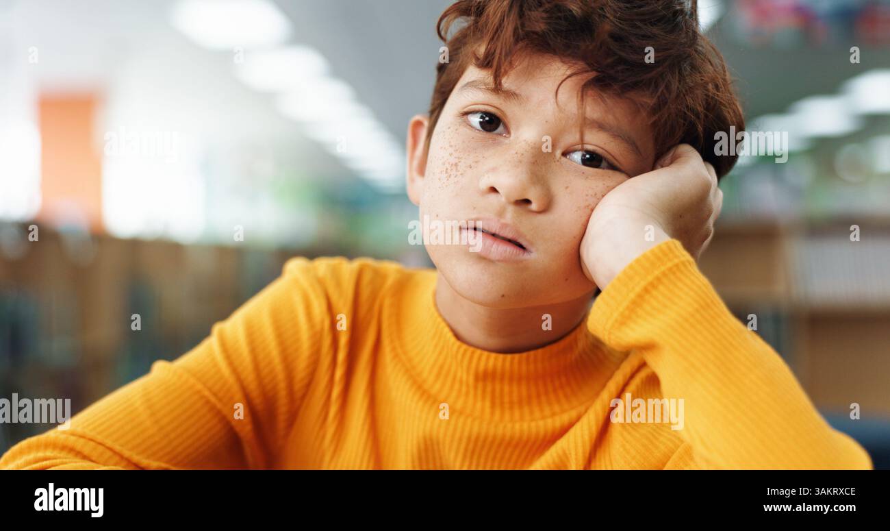 Thinking, kid and student portrait in library for planning, ideas and ...