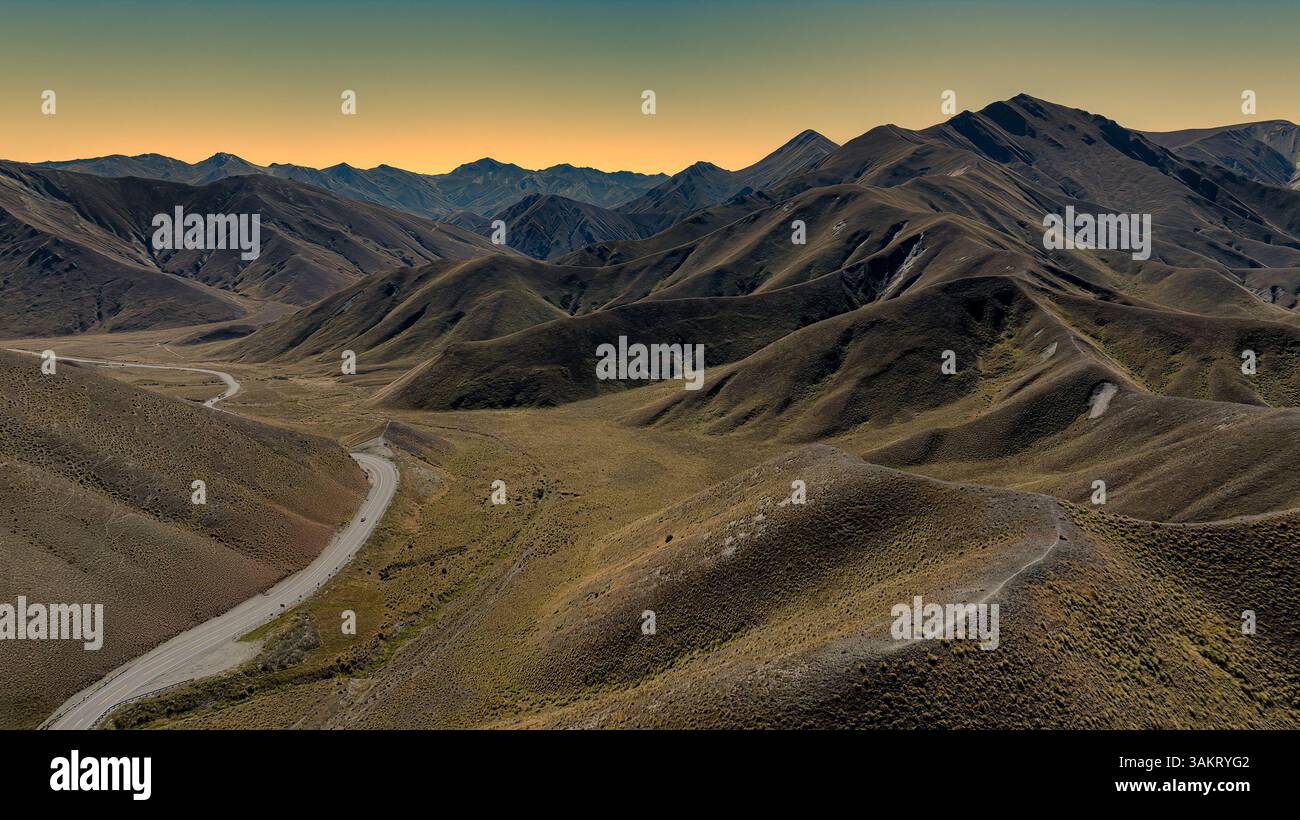 Aerial view of the alpine pass road winding its way through the arid ...