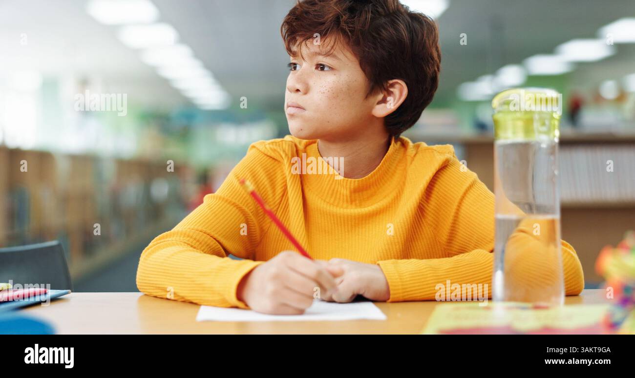 Boy, child and paper with thinking at library for learning, study and ...