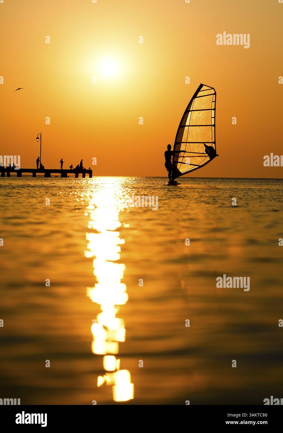 Man passing windsurf sailboard hi-res stock photography and images - Alamy