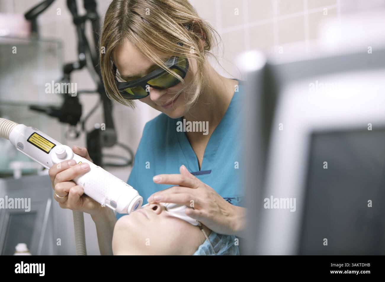 Woman having a laser skin treatment in a skincare clinic, a resurfacing ...