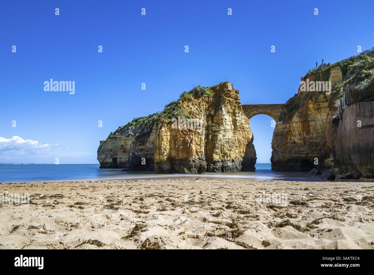 Yellow rocks and cliffs on a sandy beach. A bay by the sea, over which ...