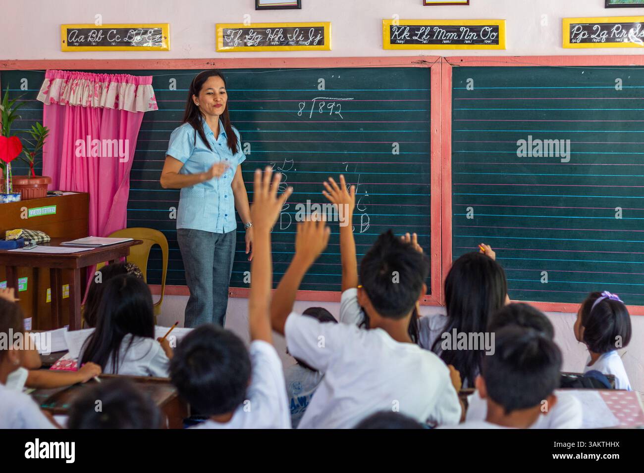 A public elementary school teacher in Batangas, Philippines teaches her ...