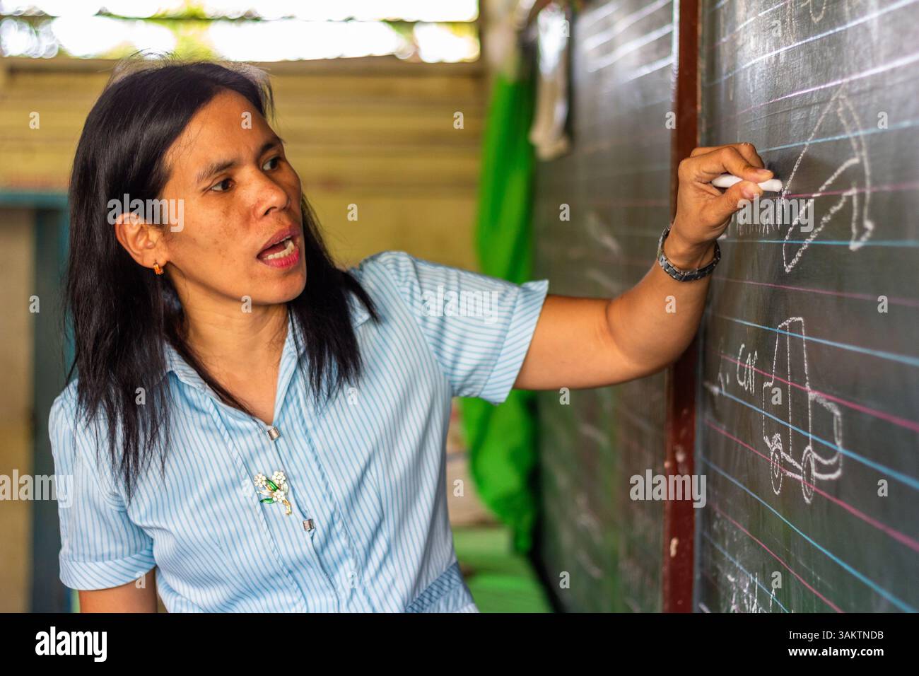 A public elementary school teacher in Batangas, Philippines teaches her ...