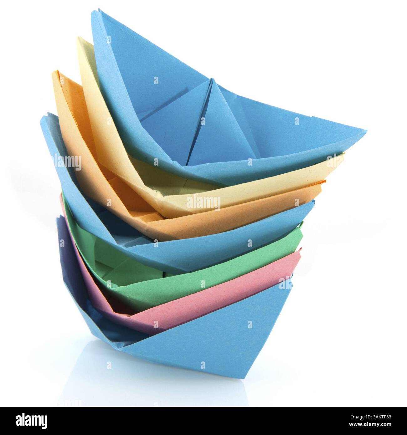 Stacked paper boats in different colors over white Stock Photo - Alamy