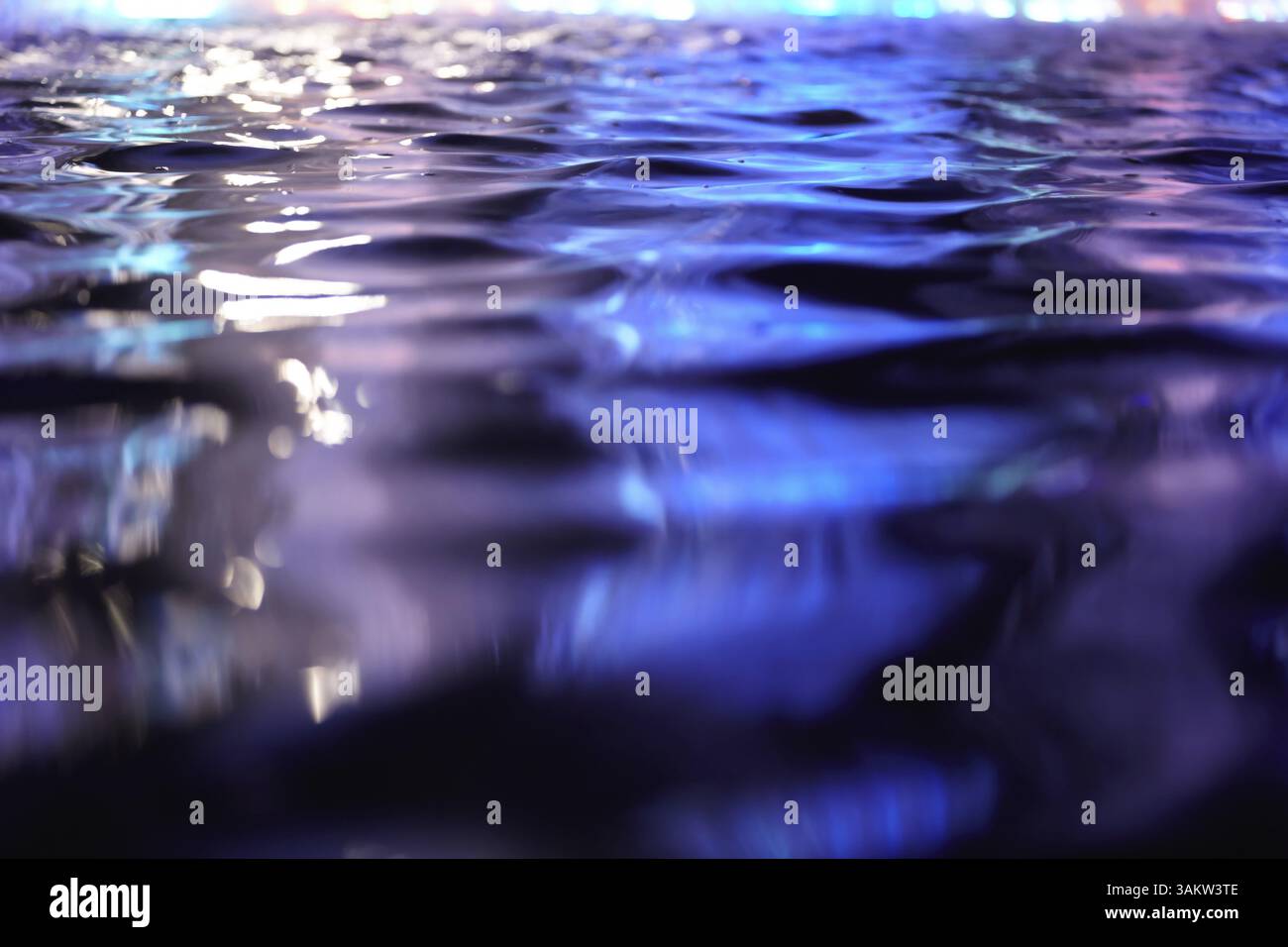 Blue and violet water surface with light reflection abstract background ...