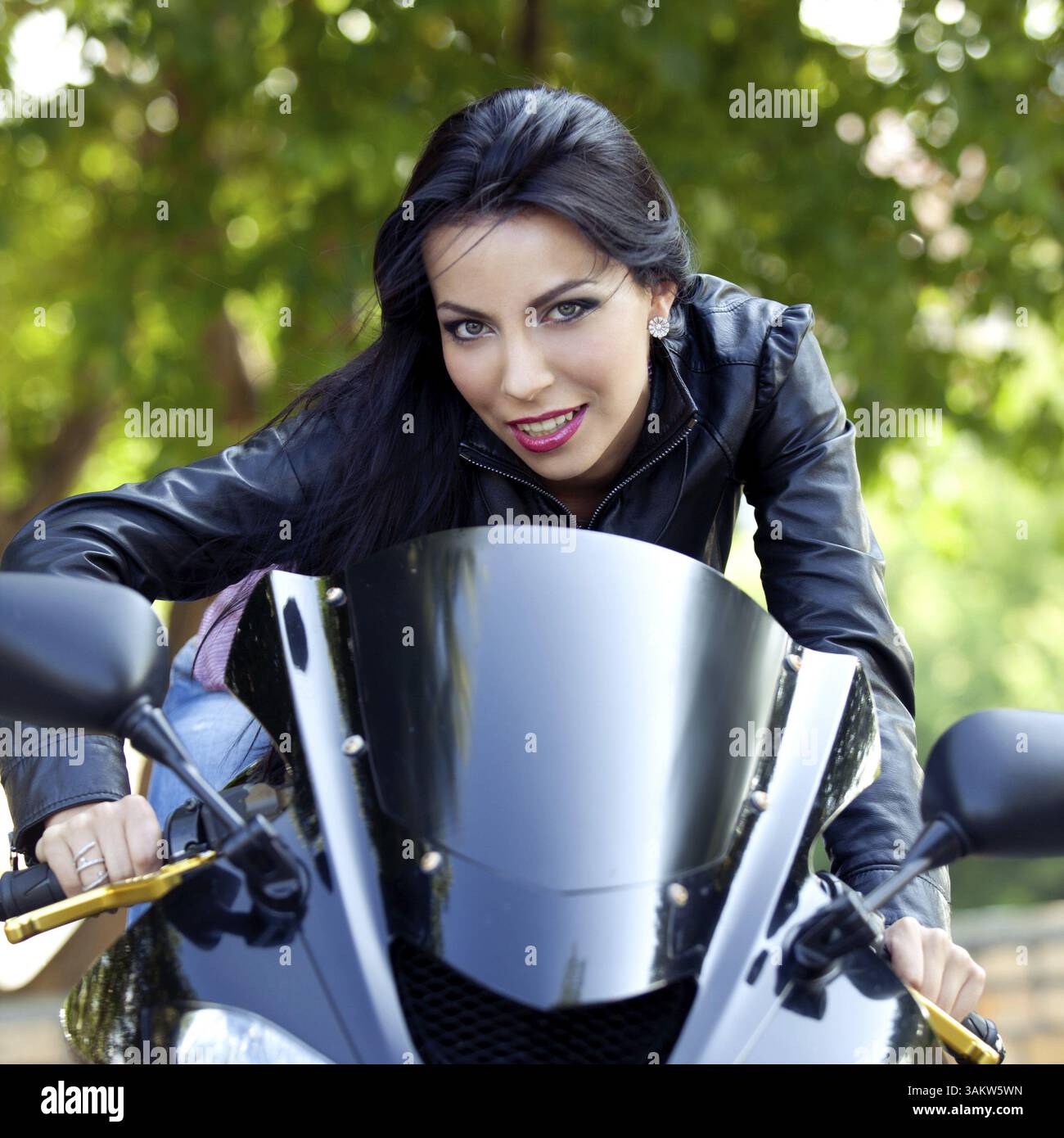 Attractive girl riding a bike Stock Photo - Alamy