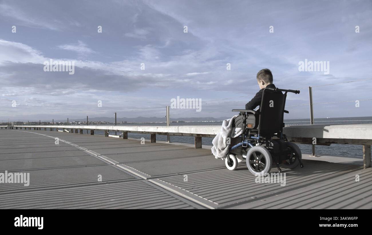 Handicapped child is lonely in this big active world. Disabled boy in ...