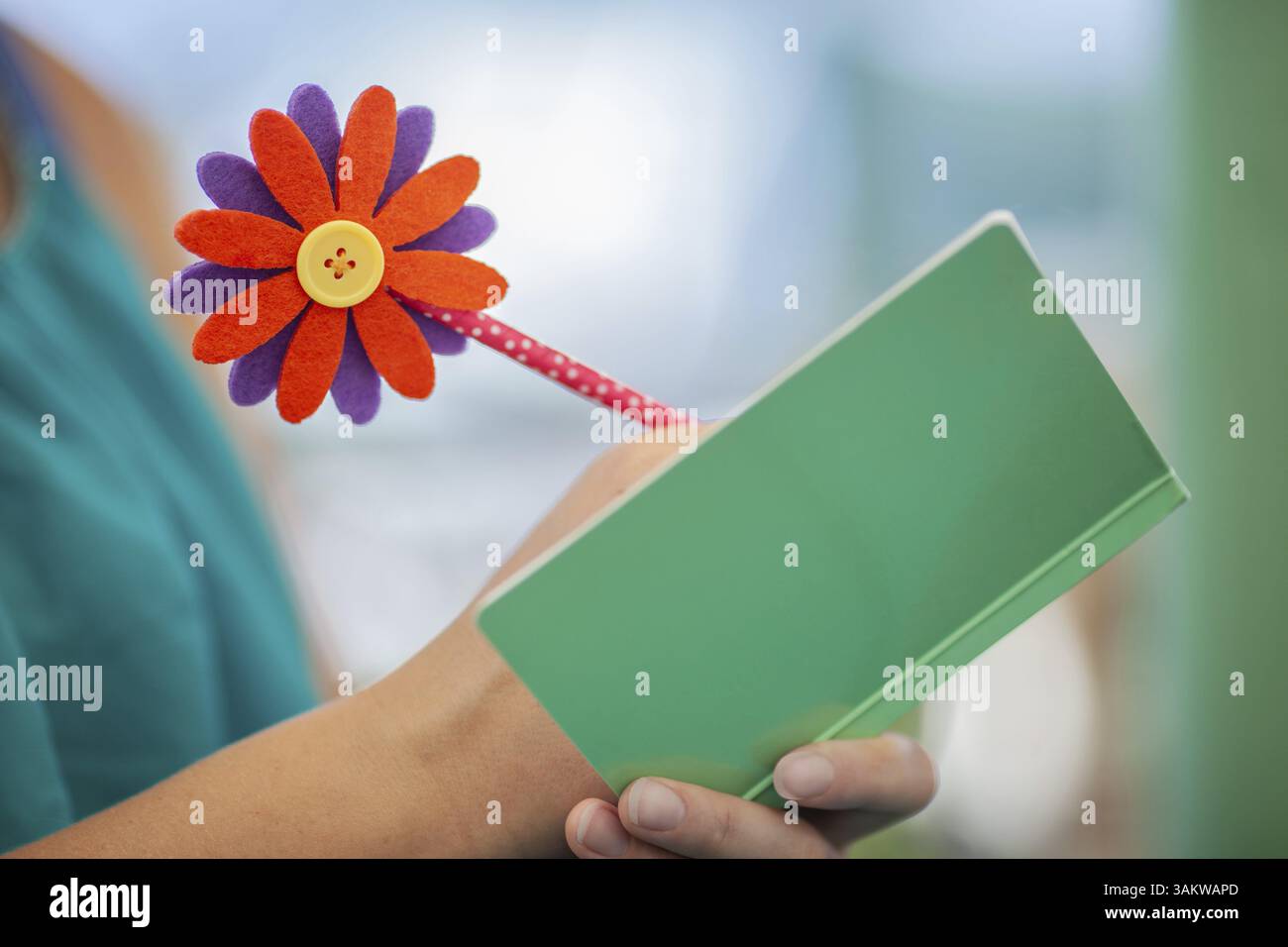 Close-up shot of a woman taking notes in notepad. Pen with bright ...