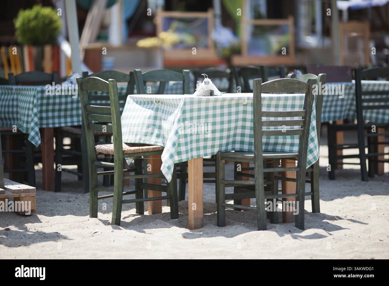 Empty Wooden Tables and Chairs with Green and White Checkered ...