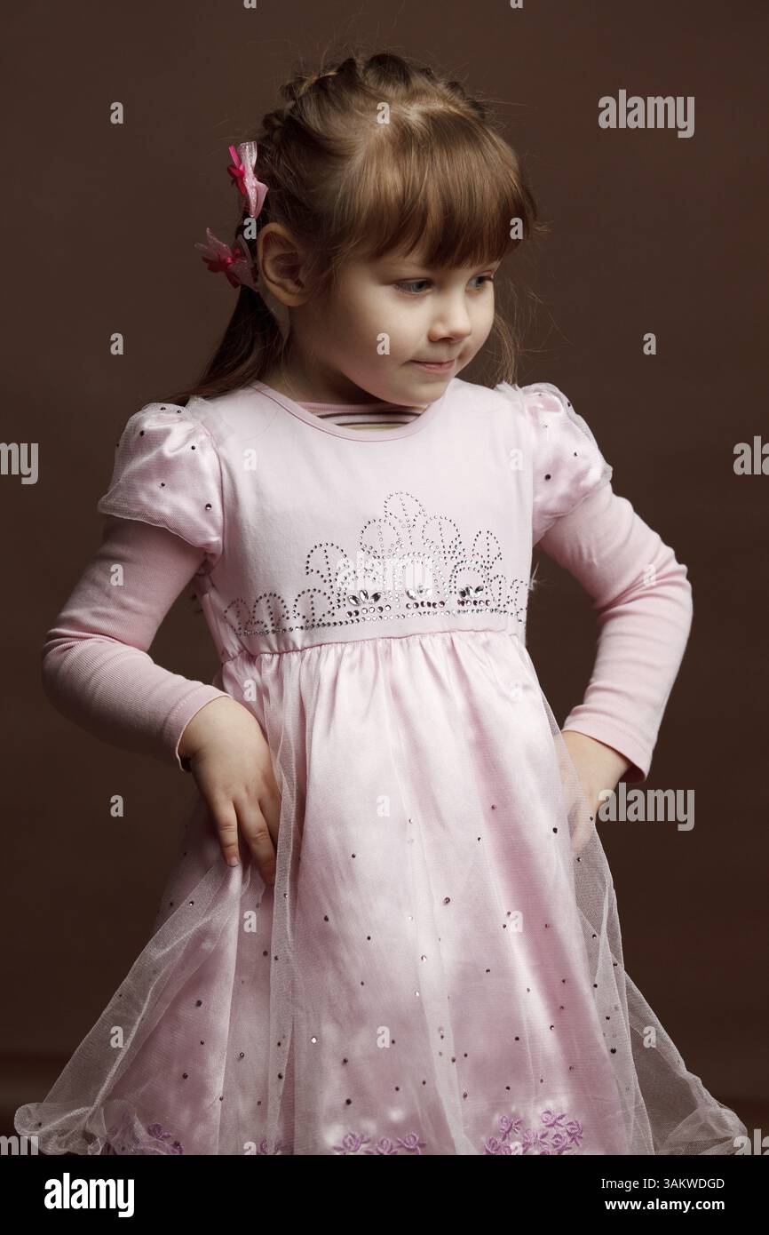Pretty confused little girl in studio Stock Photo - Alamy