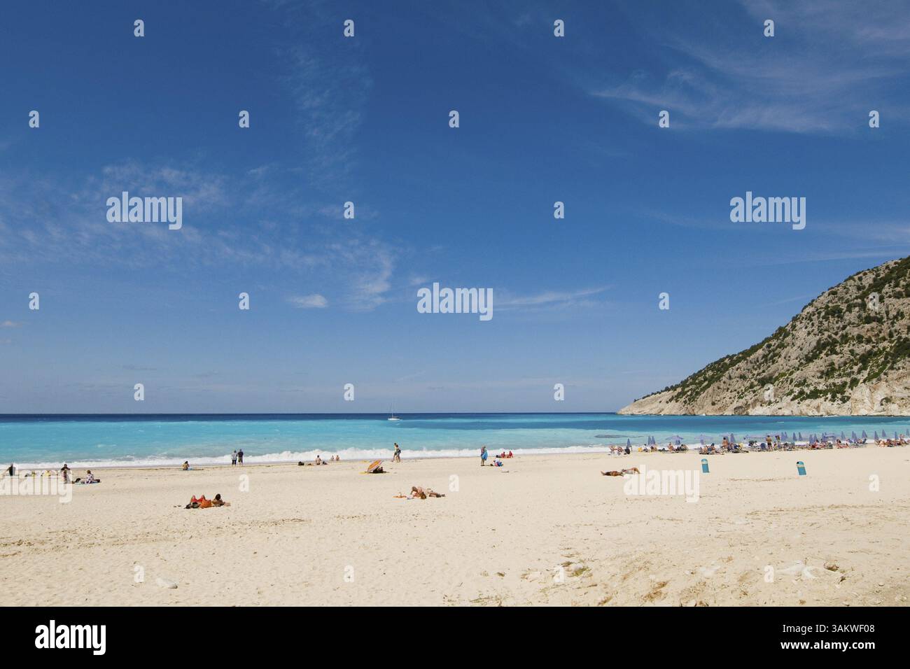 Beach with sun tanning people Stock Photo - Alamy