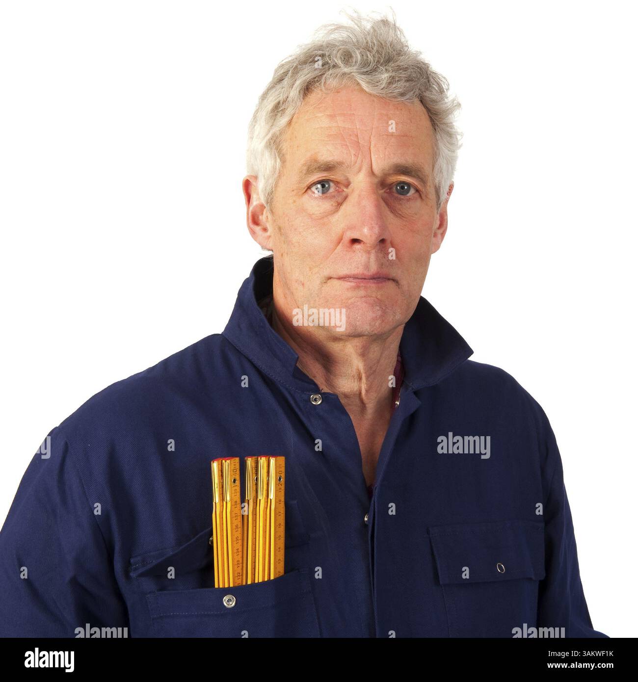 Portrait of a serious senior carpenter in blue overall Stock Photo - Alamy