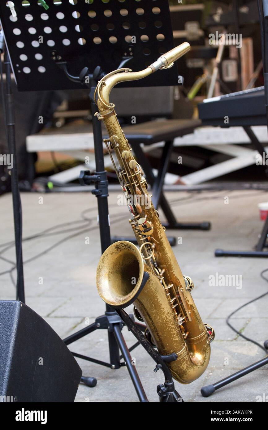 Copper saxophone on stage ready for use Stock Photo - Alamy