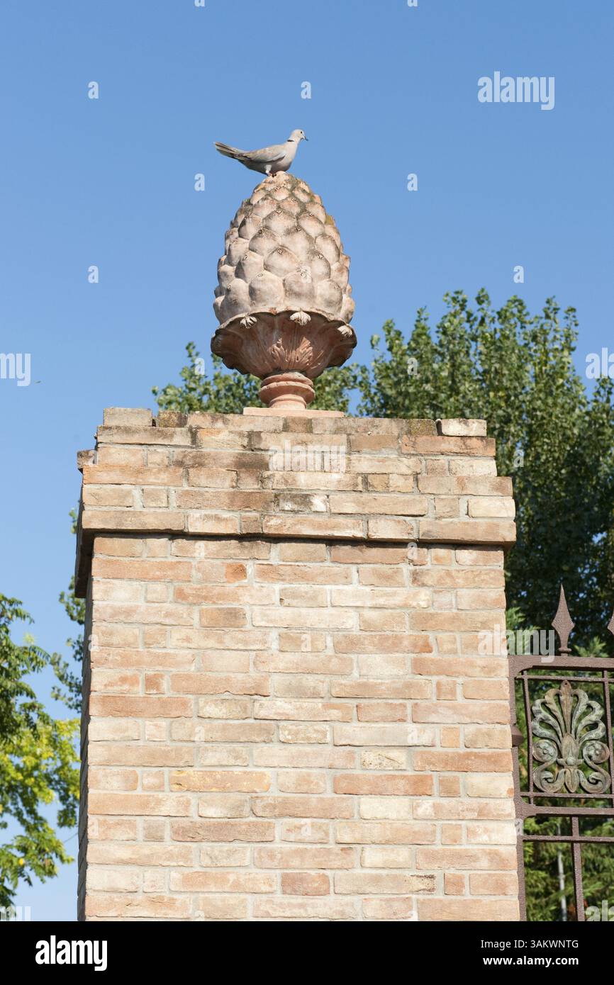 Wall with a decorative cone on top Stock Photo - Alamy