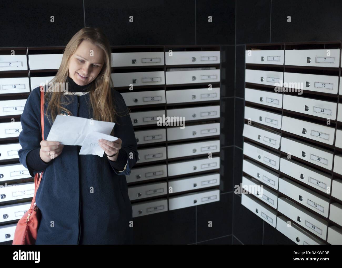 Woman reading received letter standing hi-res stock photography and ...