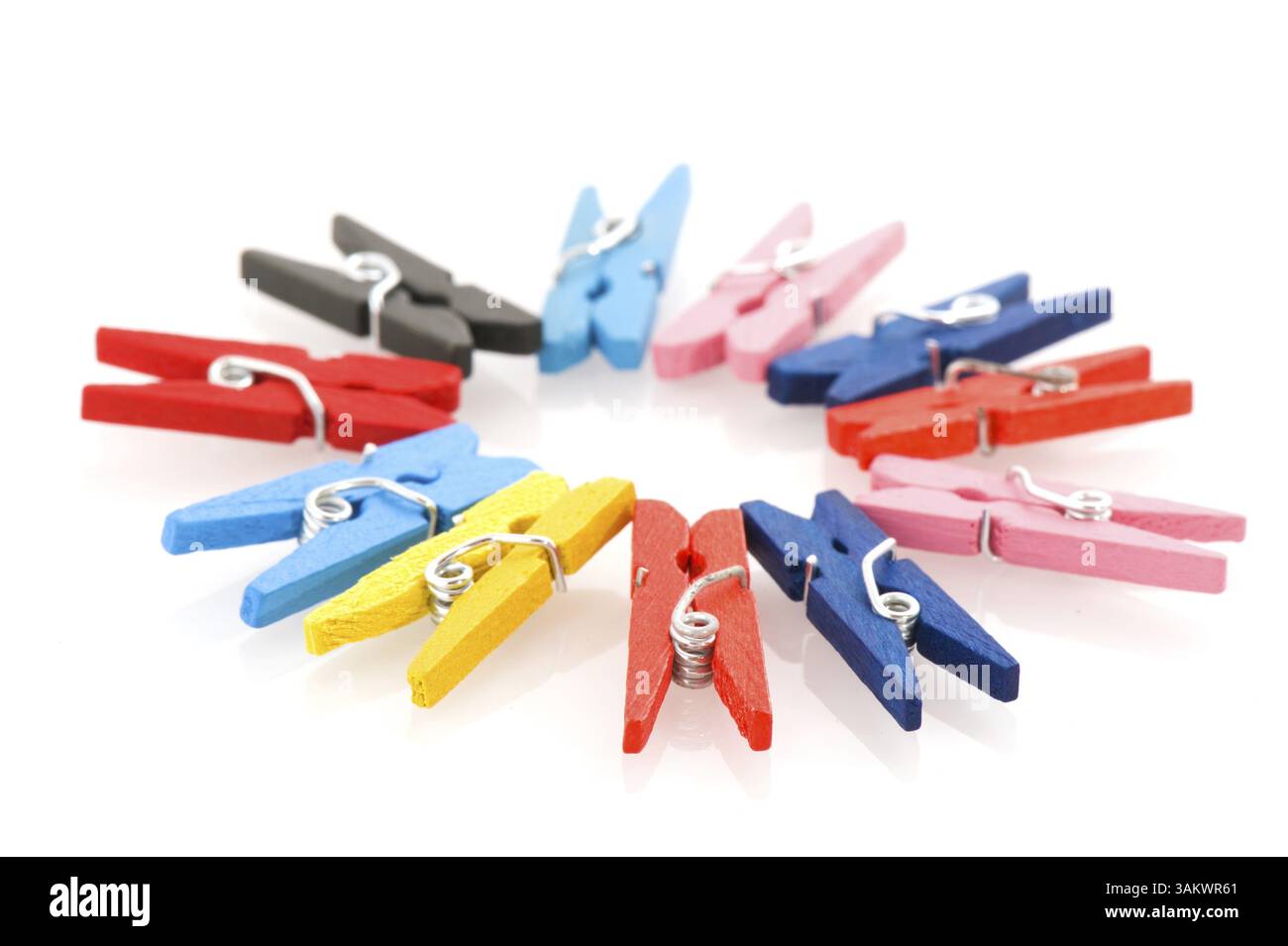 Colorful clothes pins in circle pattern isolated over white Stock Photo ...