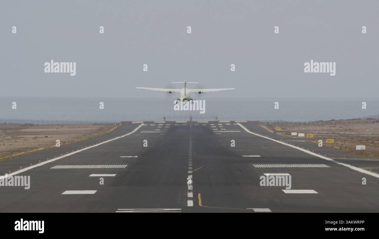 Back view of the airplane departure. Plane taking off and ascending ...