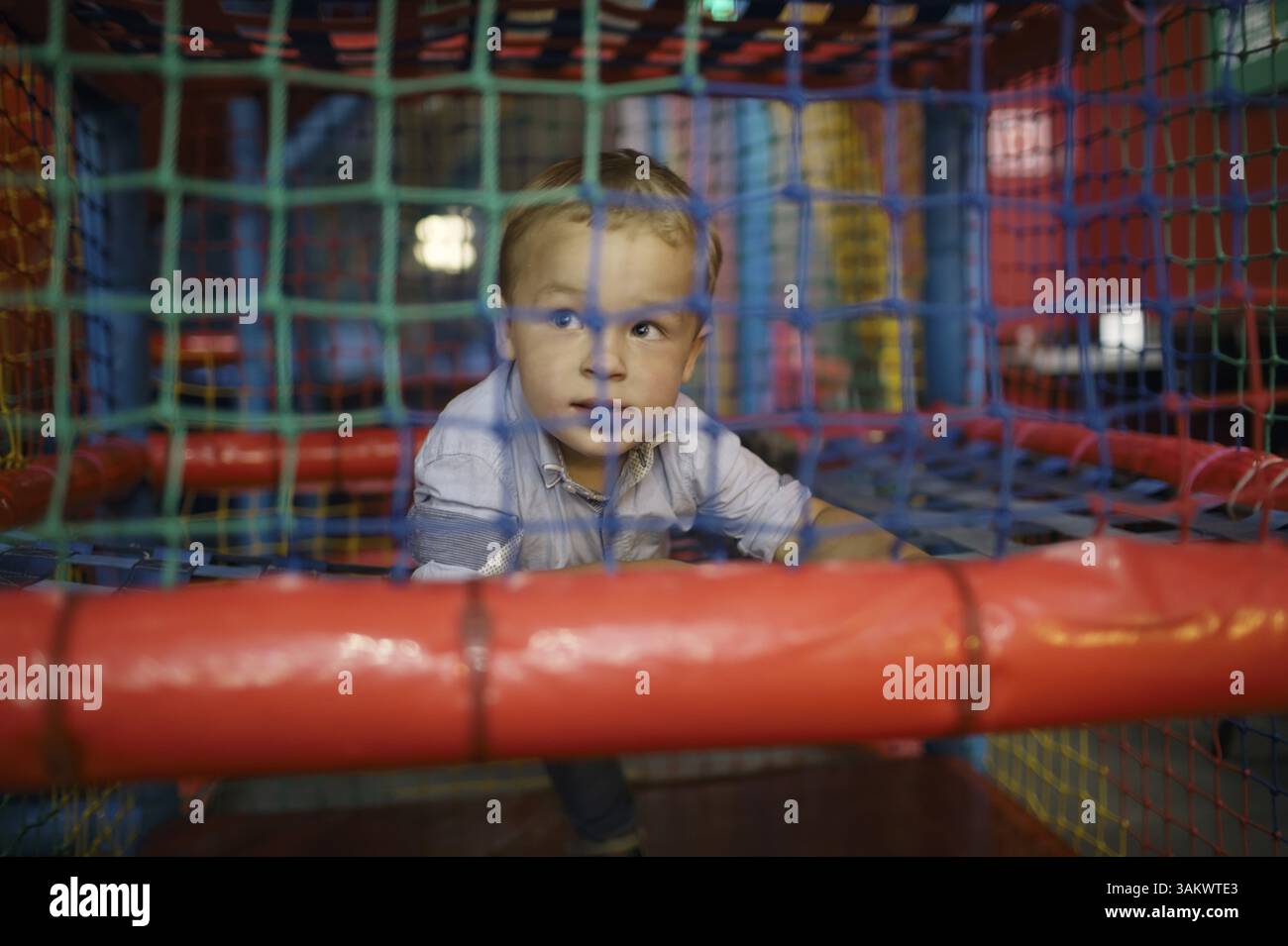 3 year old boy having fun on the playground inside trade center Stock ...