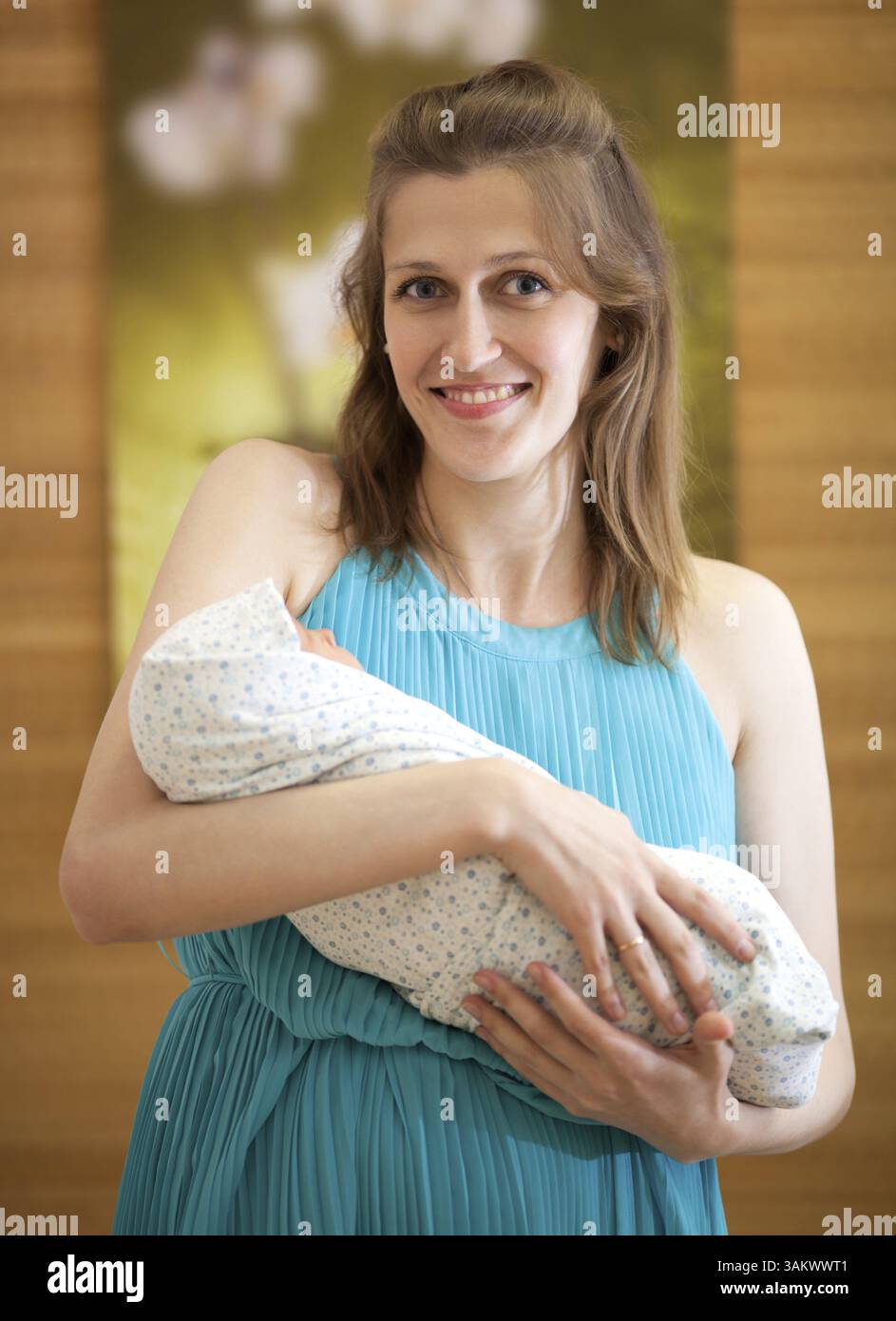 Happy new mother is holding newborn baby in arms Stock Photo - Alamy