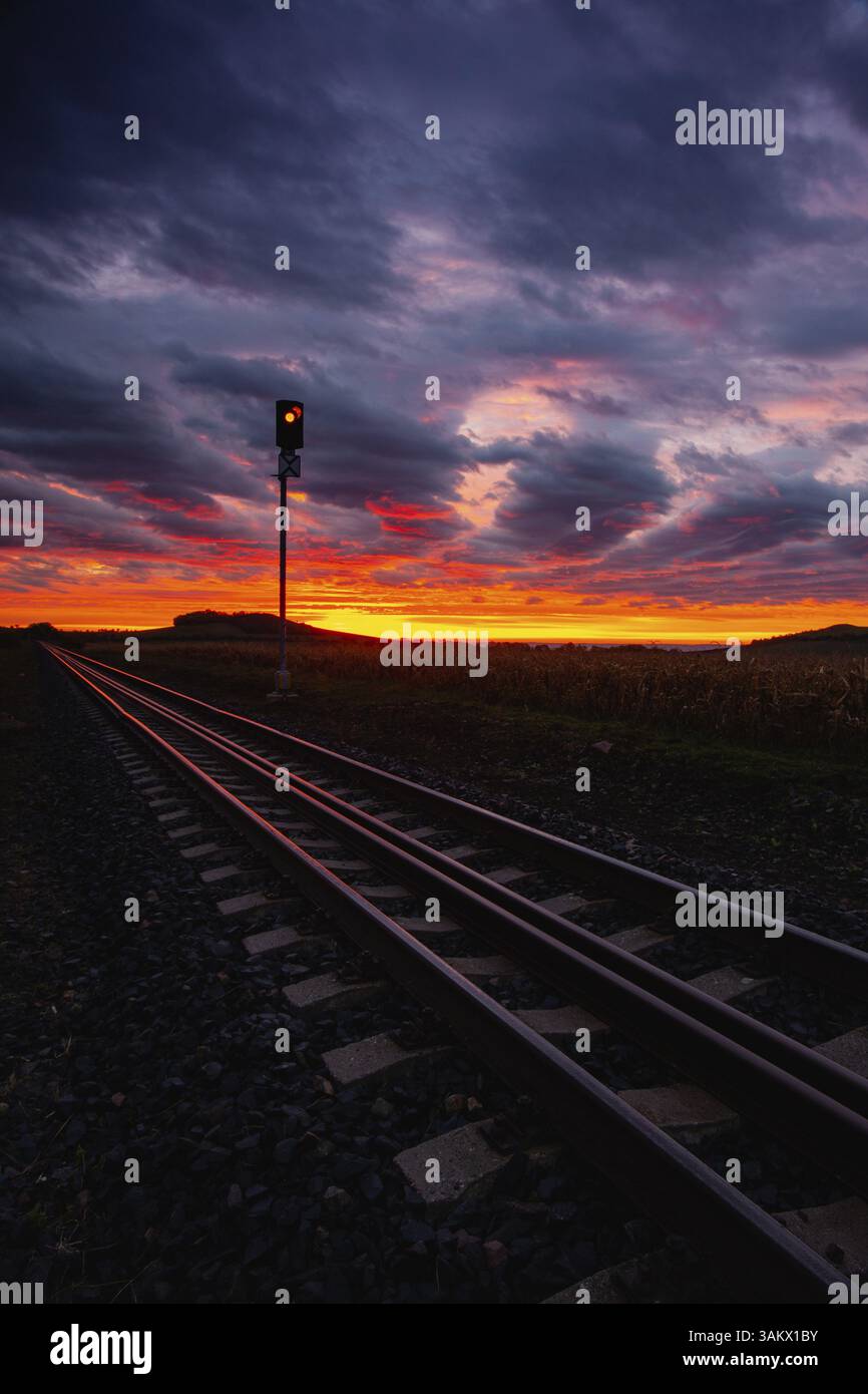 Morning train to the hell. Old Railway tracks running through a field stretch to rural ...