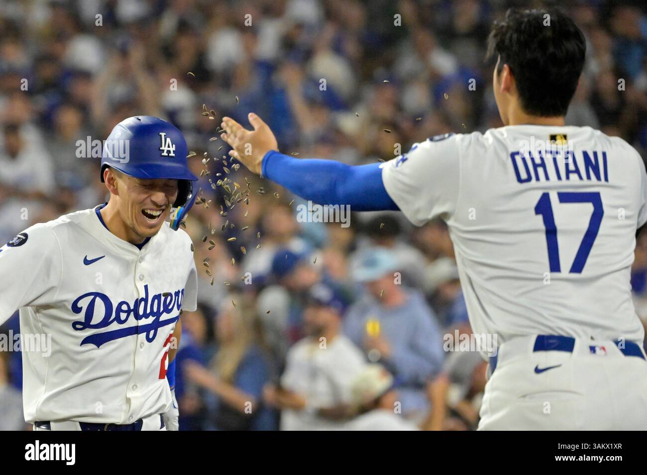 Los Angeles Dodgers center fielder Tommy Edman, left, is showered with ...