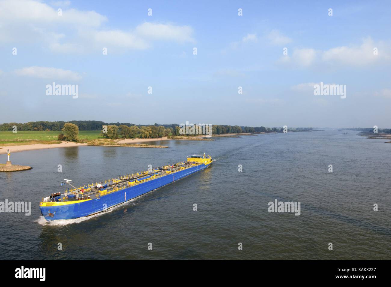 River landscape with big blue boat Stock Photo - Alamy