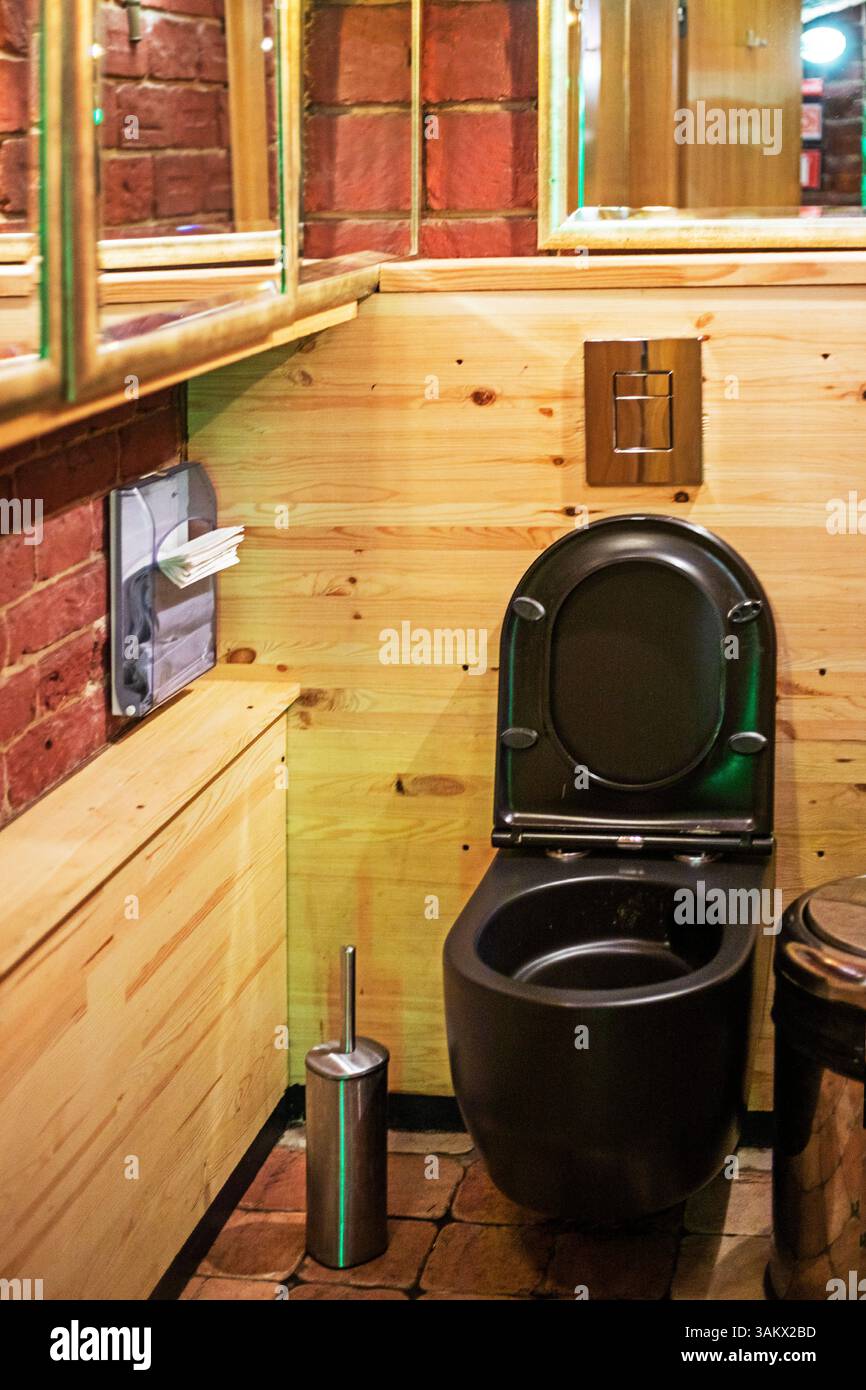 loft style toilet room with a black toilet Stock Photo - Alamy