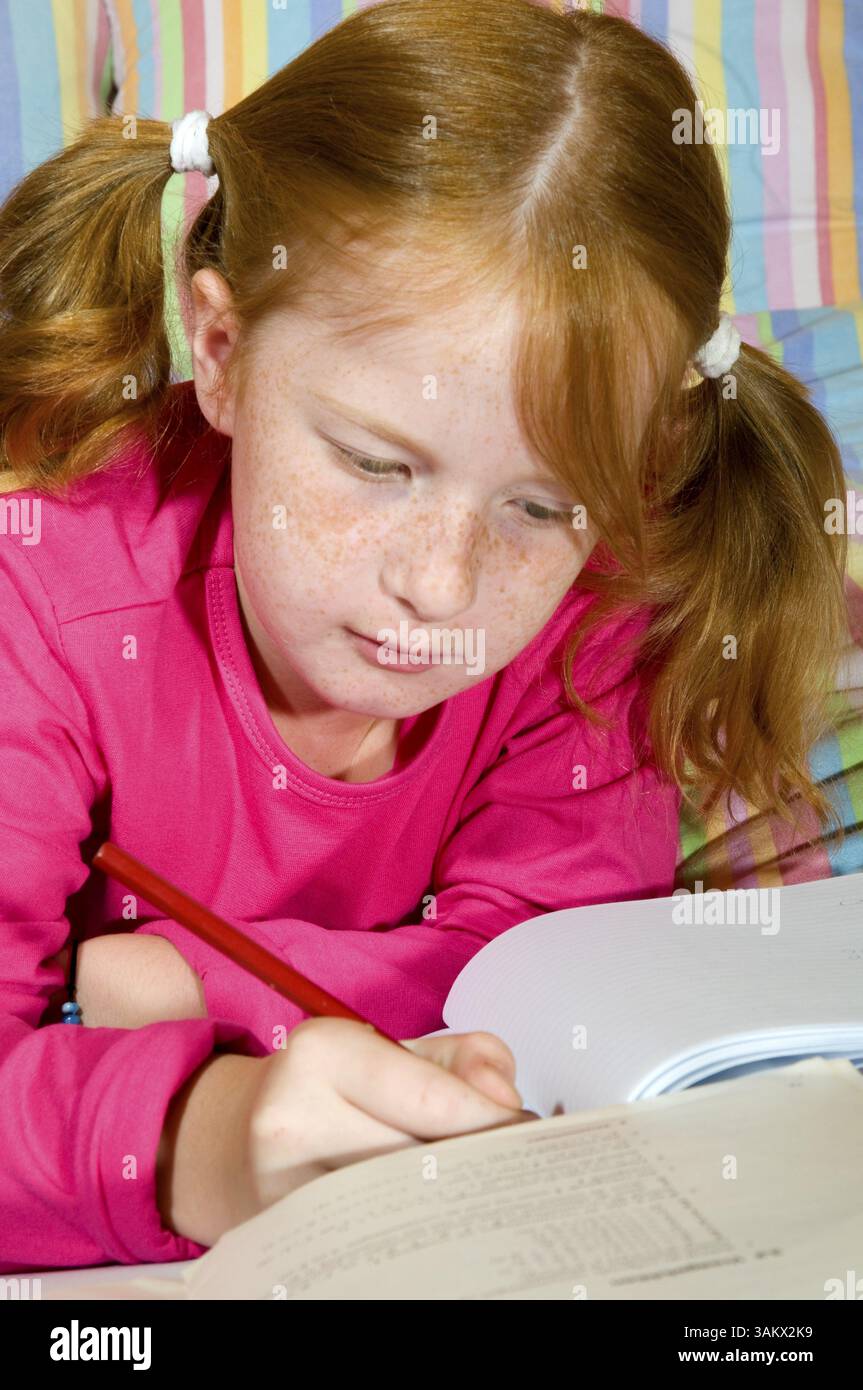 Schoolgirl is making homework Stock Photo - Alamy