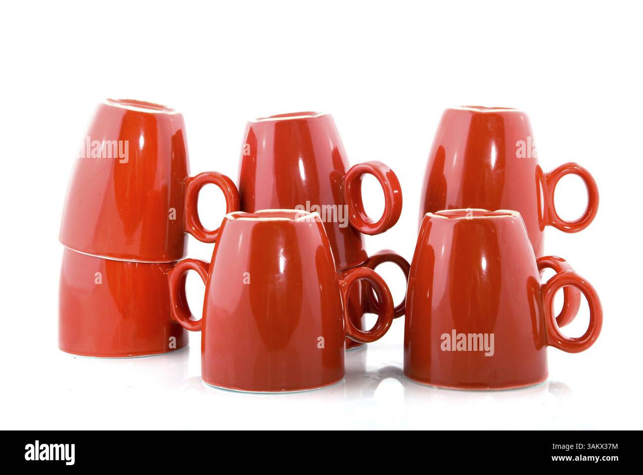 Stacked red coffee mugs Stock Photo - Alamy