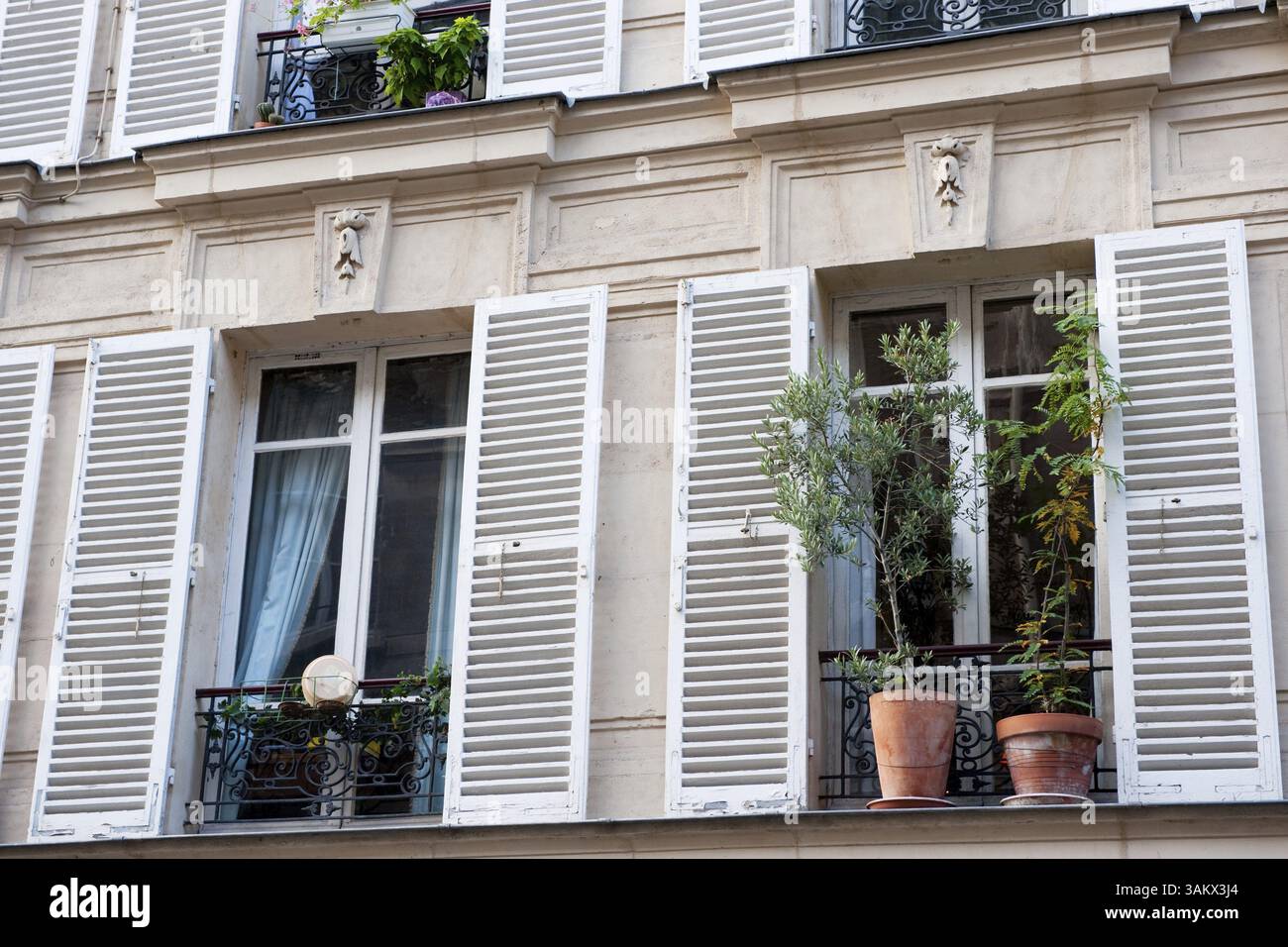 Typical French windows with balconies and blinds in Paris Stock Photo ...