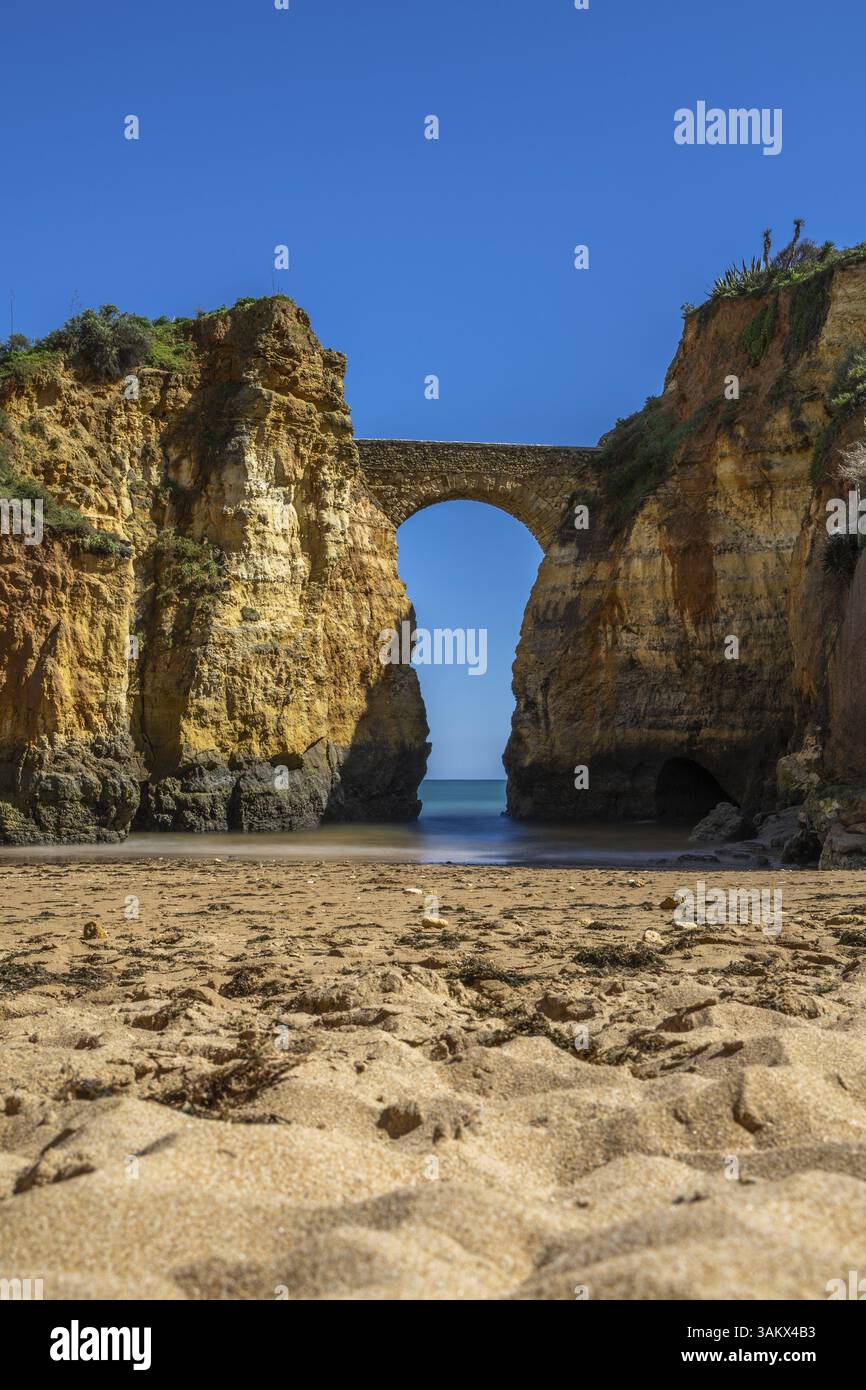 Yellow rocks and cliffs on a sandy beach. A bay by the sea, over which ...