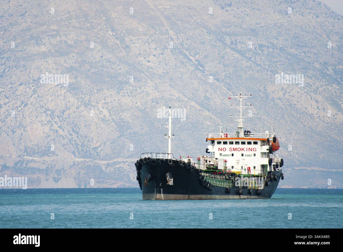 Tanker boat at the Greek sea in front of the mountains Stock Photo - Alamy