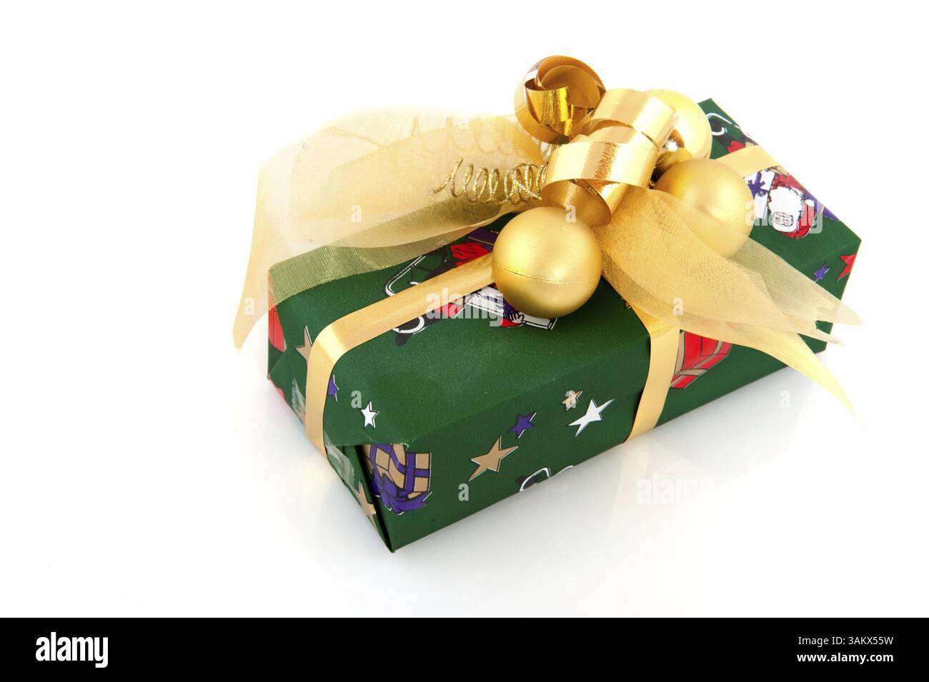 Luxury wrapped christmas present with balls and ribbon Stock Photo - Alamy