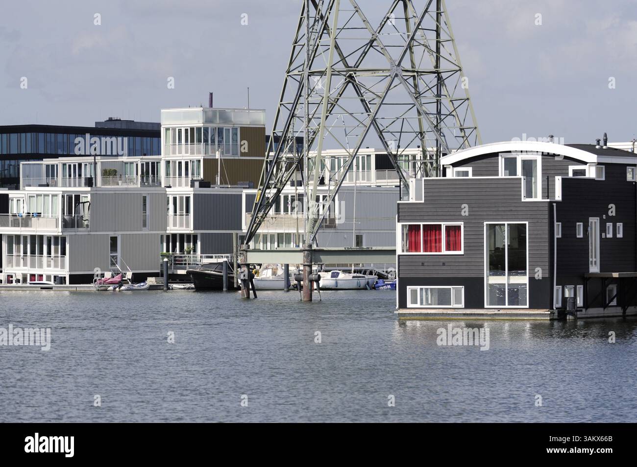 Electricity pylon in residential area, housing construction on the ...