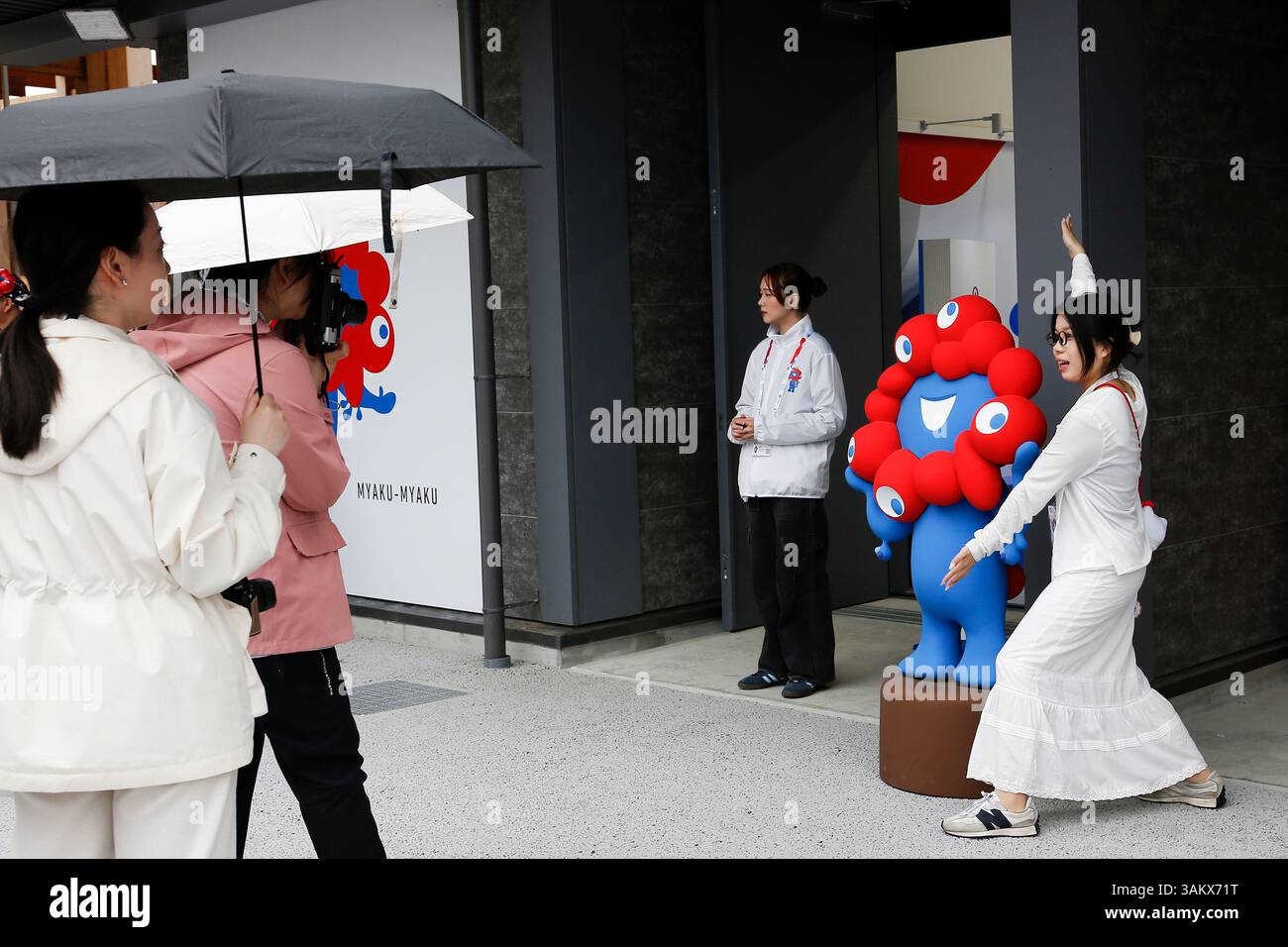 Osaka, Kansai, Japan. 13th Apr, 2025. A woman poses for a picture with ...