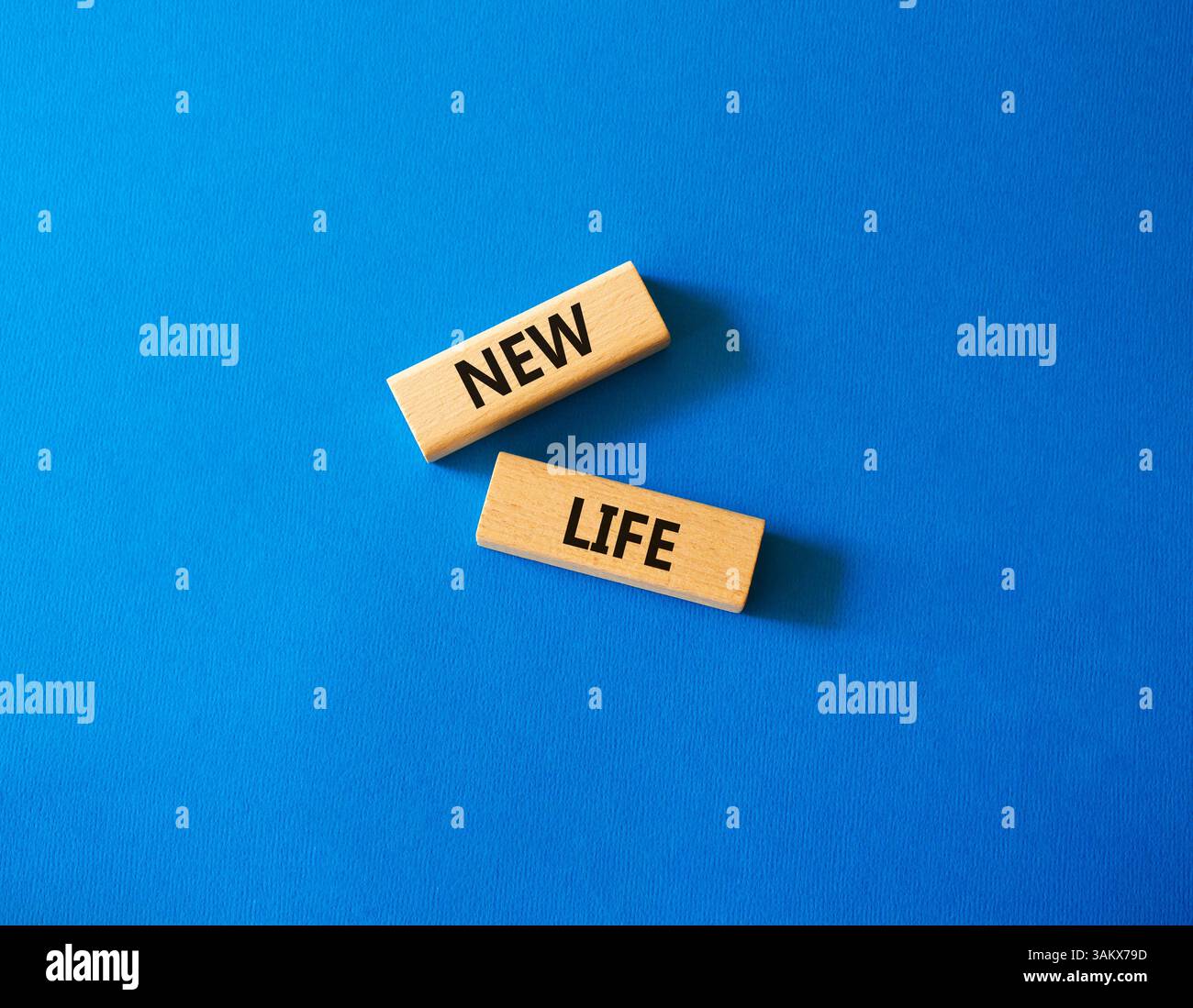 New life symbol. Wooden blocks with words New life. Beautiful blue ...