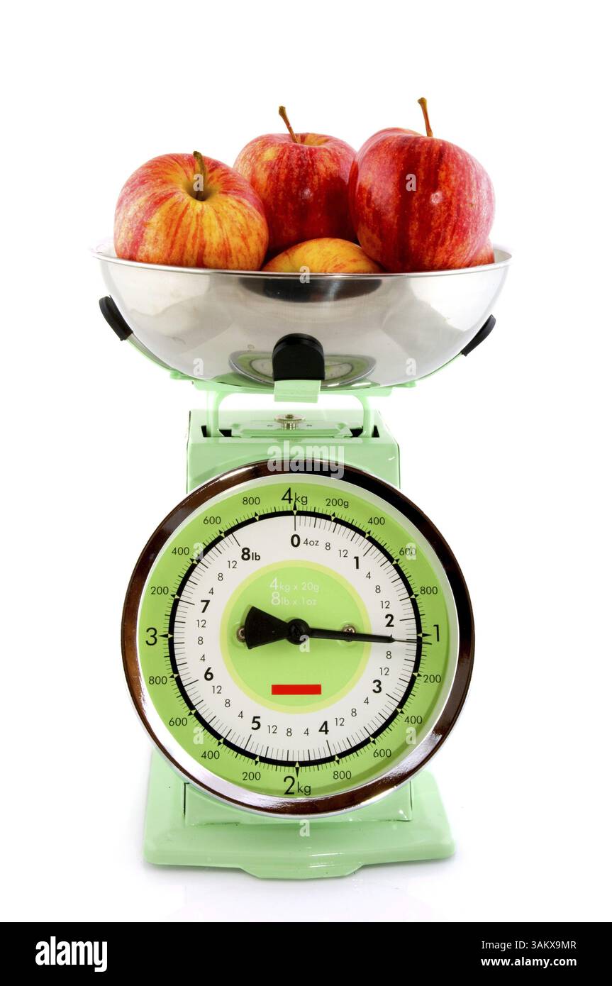 The weight of red apples at a retro kitchen scale Stock Photo - Alamy