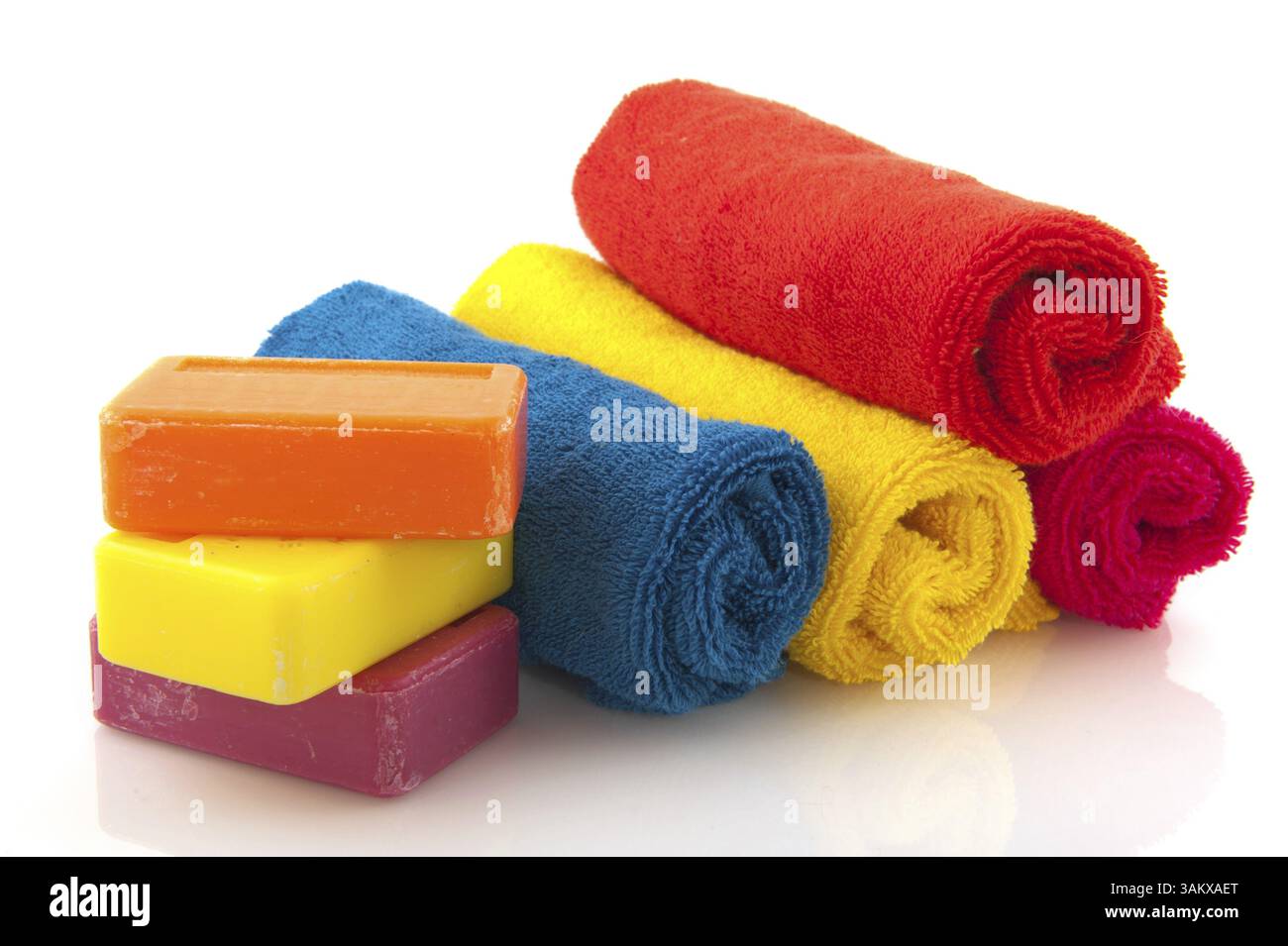 Colorful rolled towels with bars soap isolated over white Stock Photo ...
