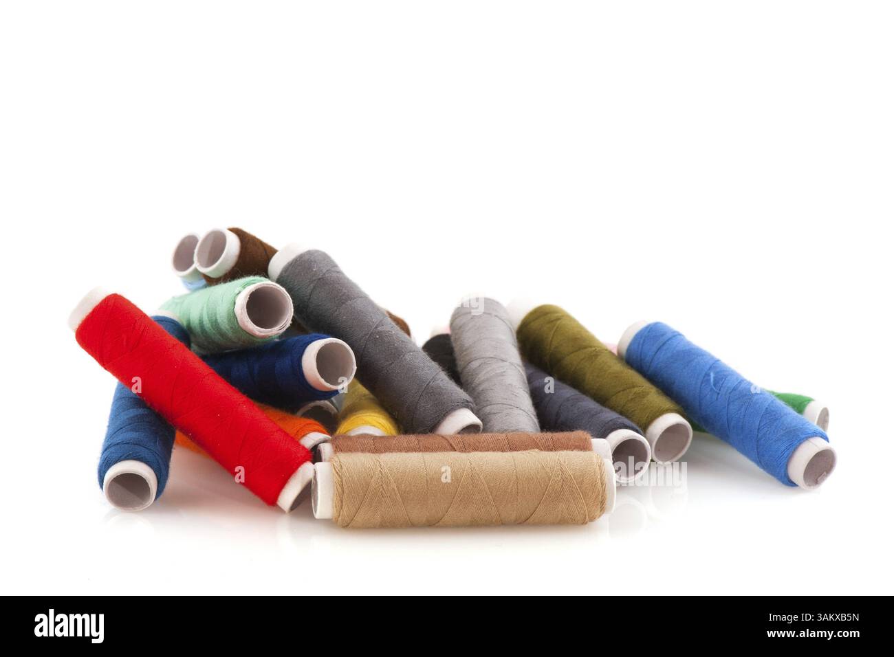 Colorful sewing threads on spools isolated over white Stock Photo - Alamy