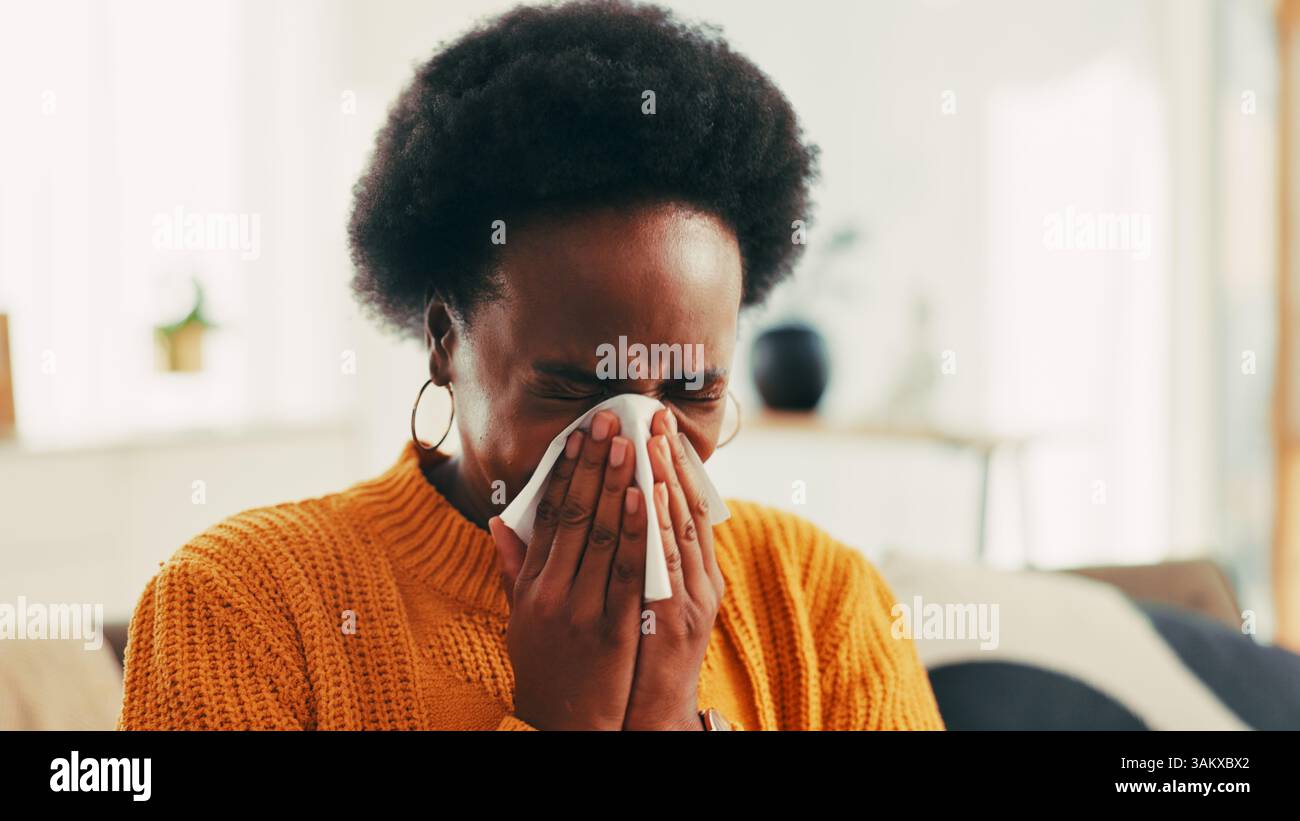 Blowing nose, sick and black woman in home with flu, cold or allergies ...