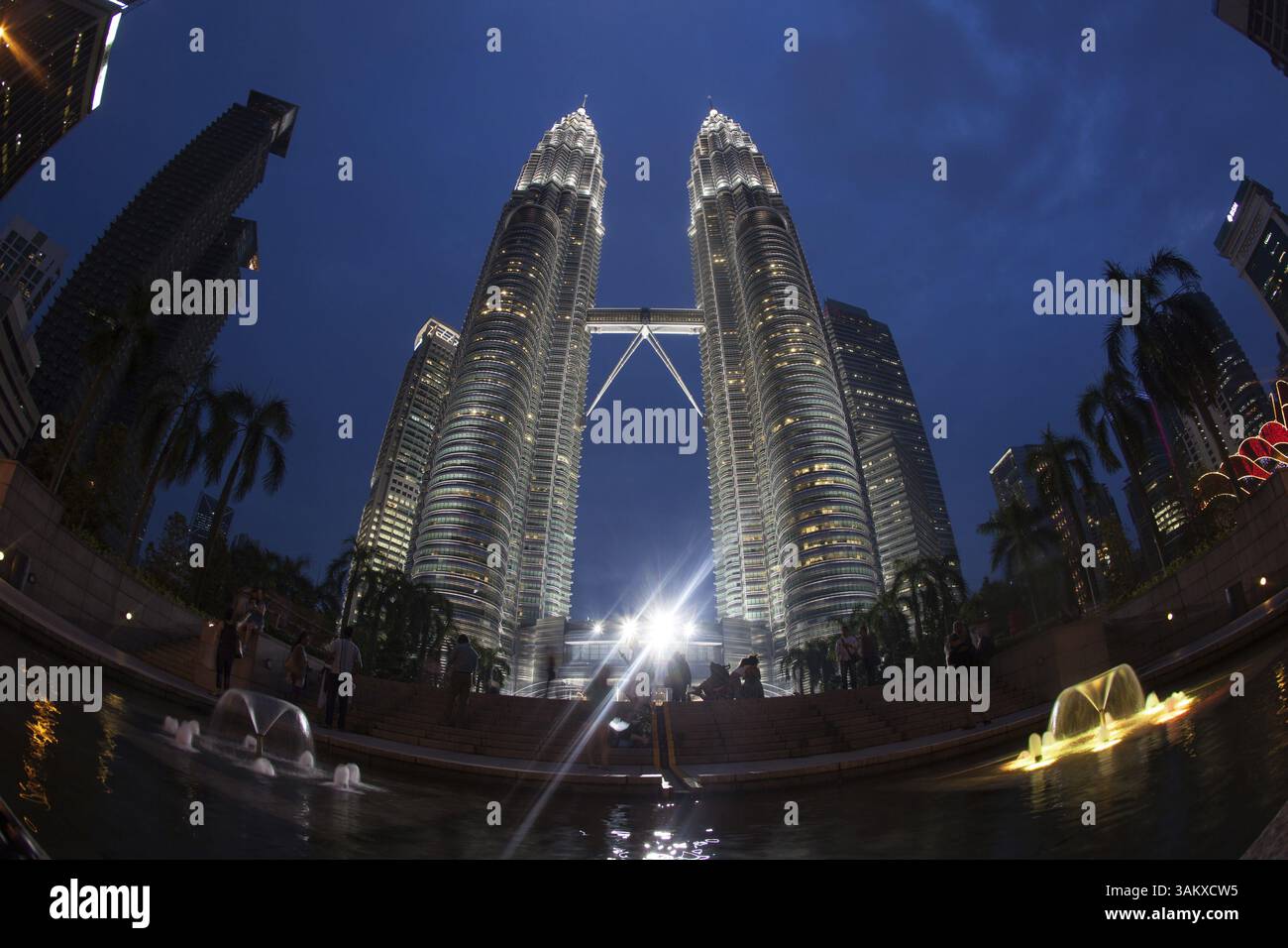 Wide and low angle shot of people in front of Petronas Twin Towers ...