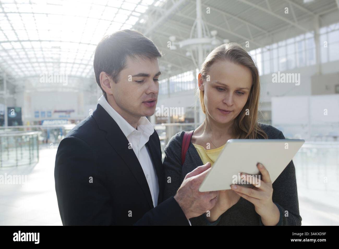 Businessman and his secretary talking on business using tablet computer ...
