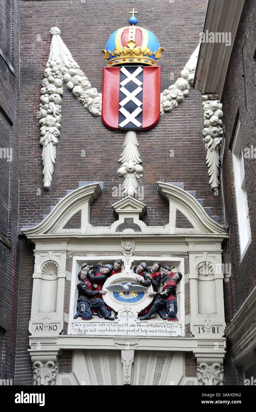 Amsterdam city coat of arms above the Weeshuispoort Tor, entrance to ...